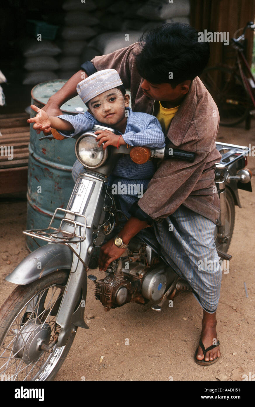 A father and child on a motorbike. Tenasserim region, Myanmar, Burma ...
