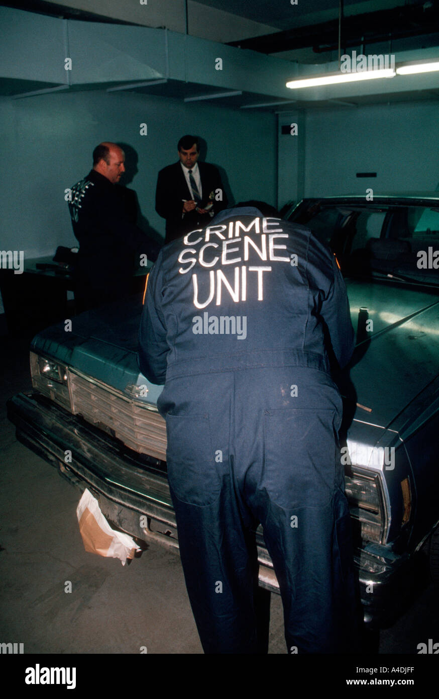 Members of the NYPD Crime Scene Unit investigate the automobile used by ...