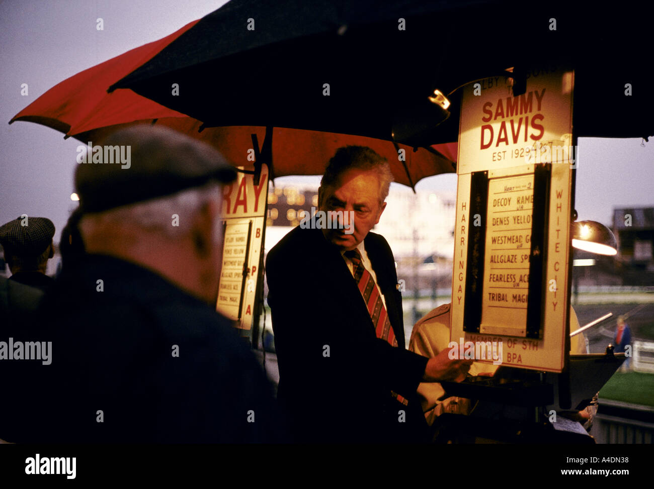 A bookie at the dog races, Harringay Stadium, London, UK Stock Photo ...