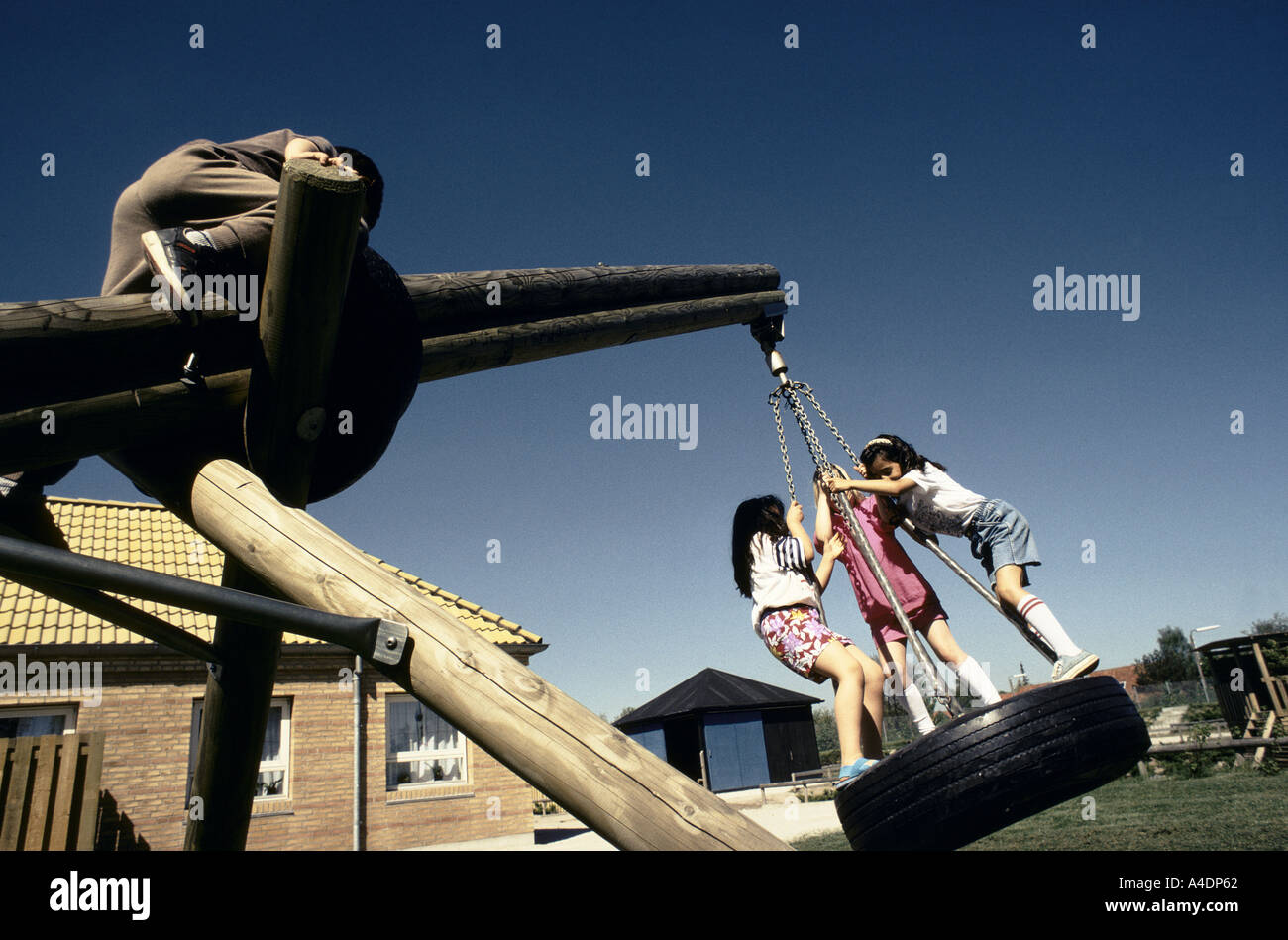 Children on a wooden playstructure in the open air playground at the ...