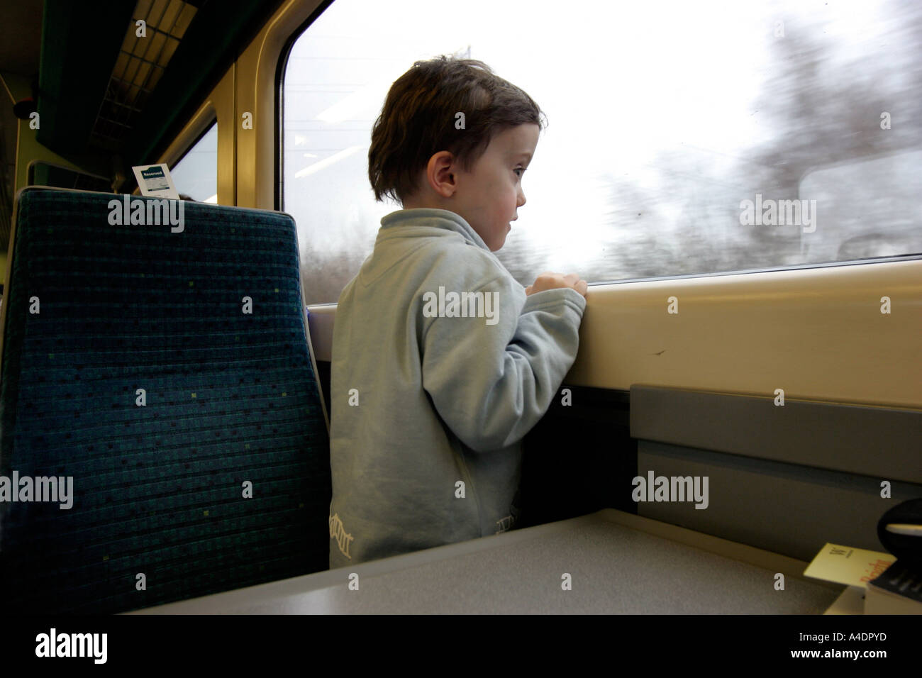 Lewis aged four on his first long train journey looks in wonder out of ...