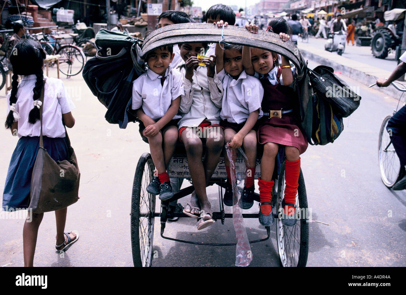 Children riding on the back of a rickshaw. Jaipur, Rajasthan, India ...