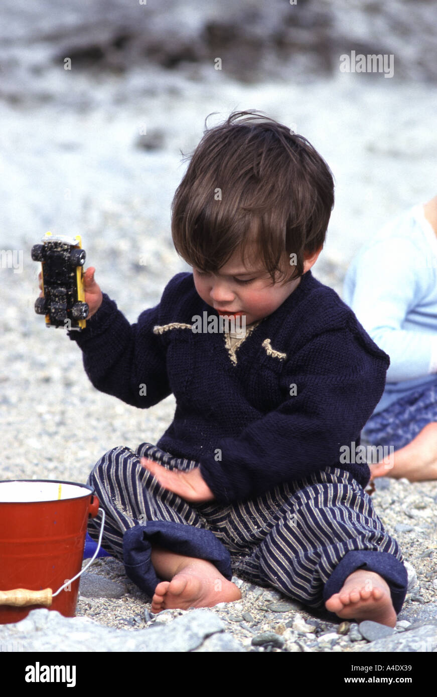 Little boy playing on the beach Stock Photo - Alamy
