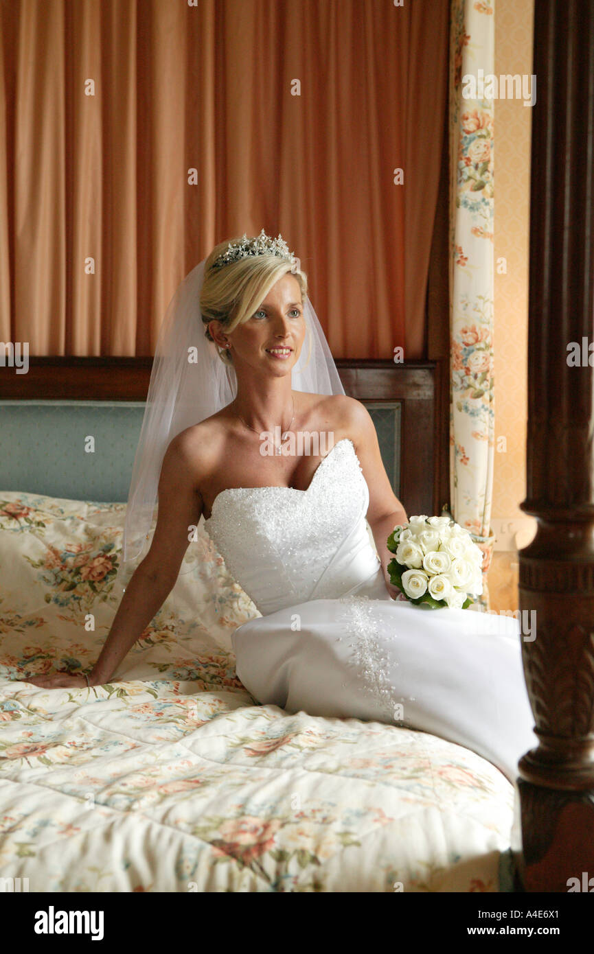 Bride sitting on bed Stock Photo - Alamy