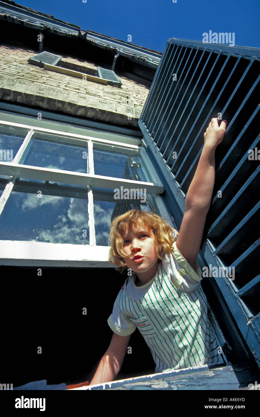 Young girl looking out of window Stock Photo - Alamy