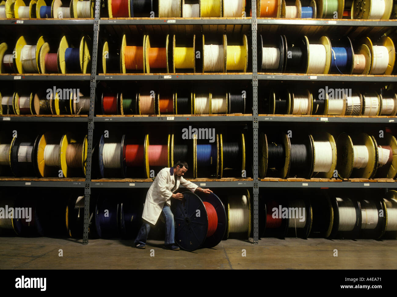 worker rolling electrical wire on spools after being produced Stock ...