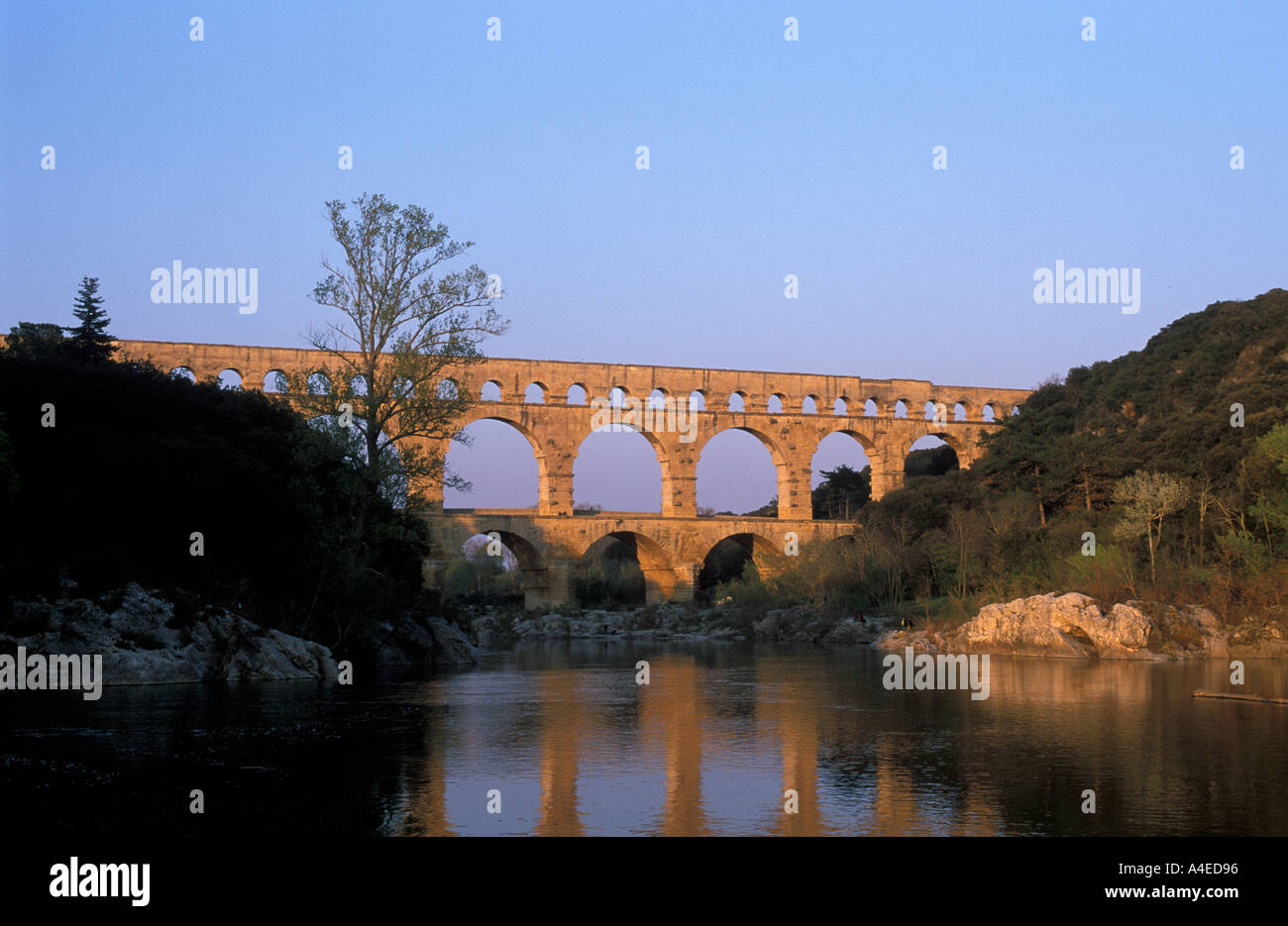 reflection in the river of the roman bridge pont du gard near nimes in ...