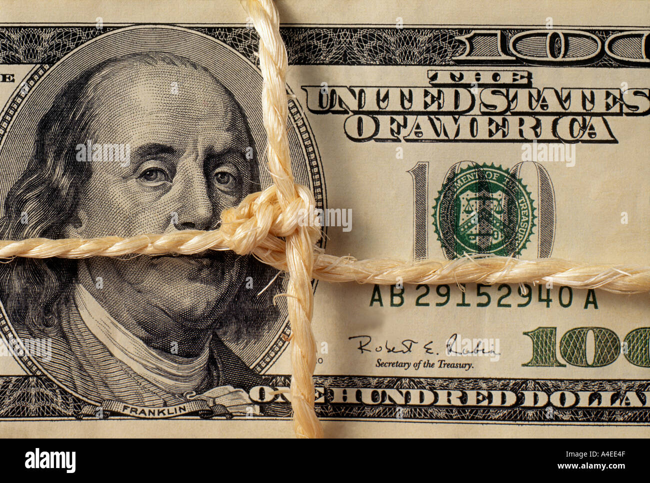 hundred dollar bill tied up with string Stock Photo - Alamy