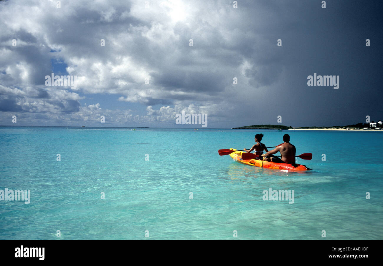 a couple canoeing across the bay at the resort of cap jaluca on the ...