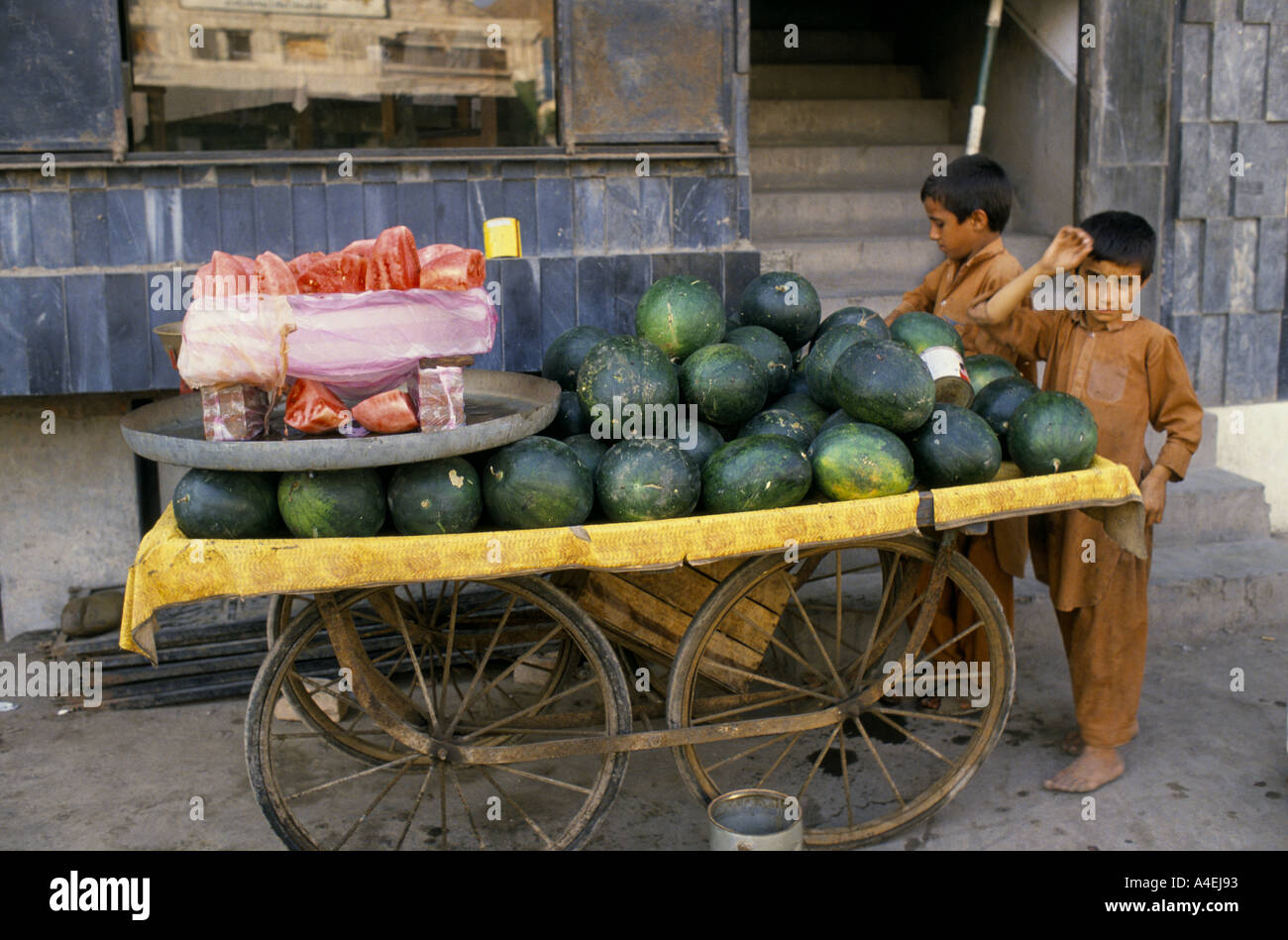 Two young boys selling watermelons on a cart . Pakistan Stock Photo - Alamy