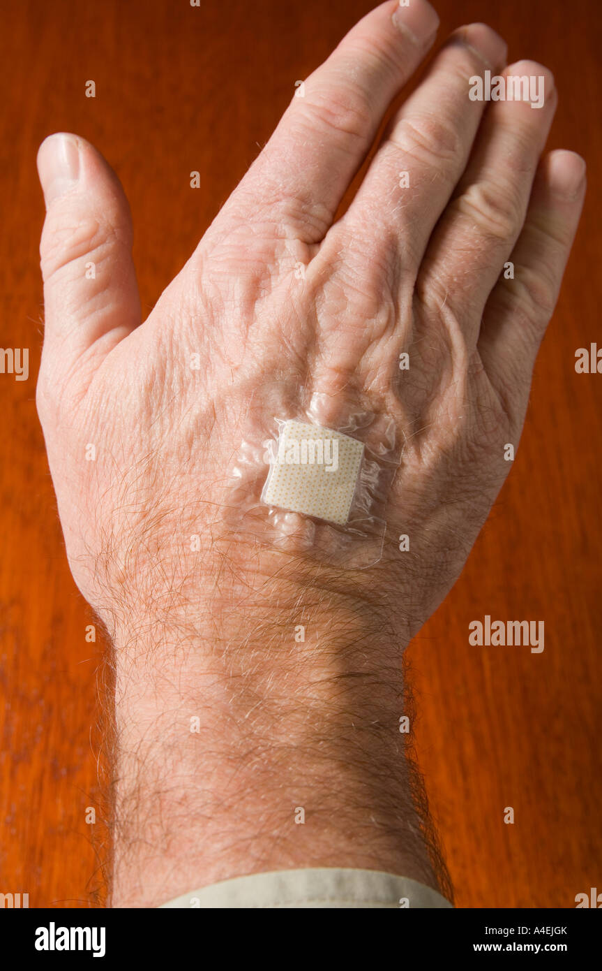 A band-aid on a man's hand Stock Photo - Alamy