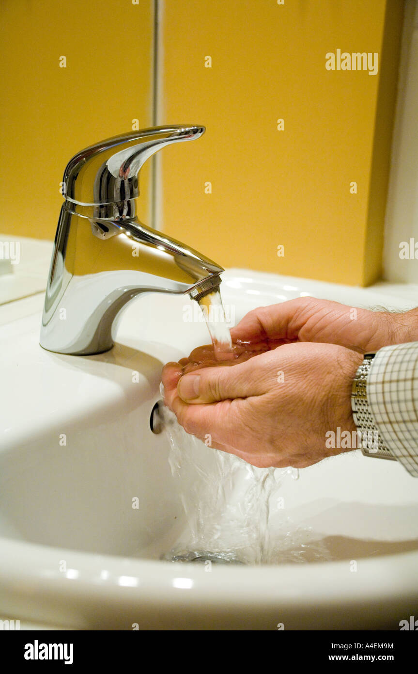 A man washing his hands, in a bathroom Stock Photo - Alamy