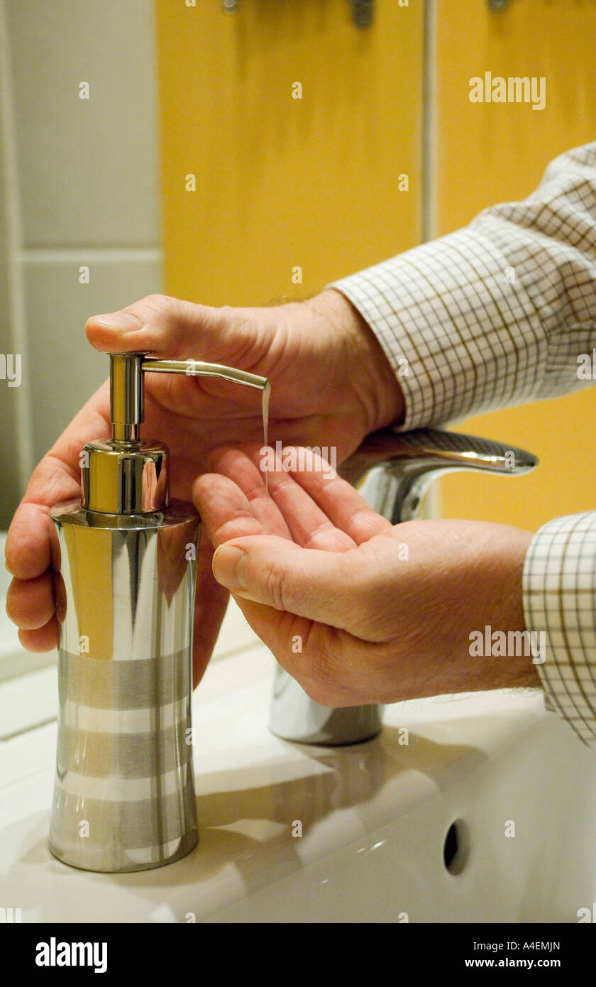 A man washing his hands, in a bathroom Stock Photo - Alamy