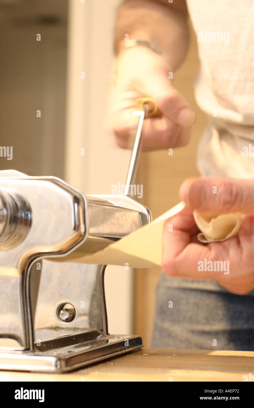 Making fresh pasta with a hand-cranked pasta machine Stock Photo - Alamy