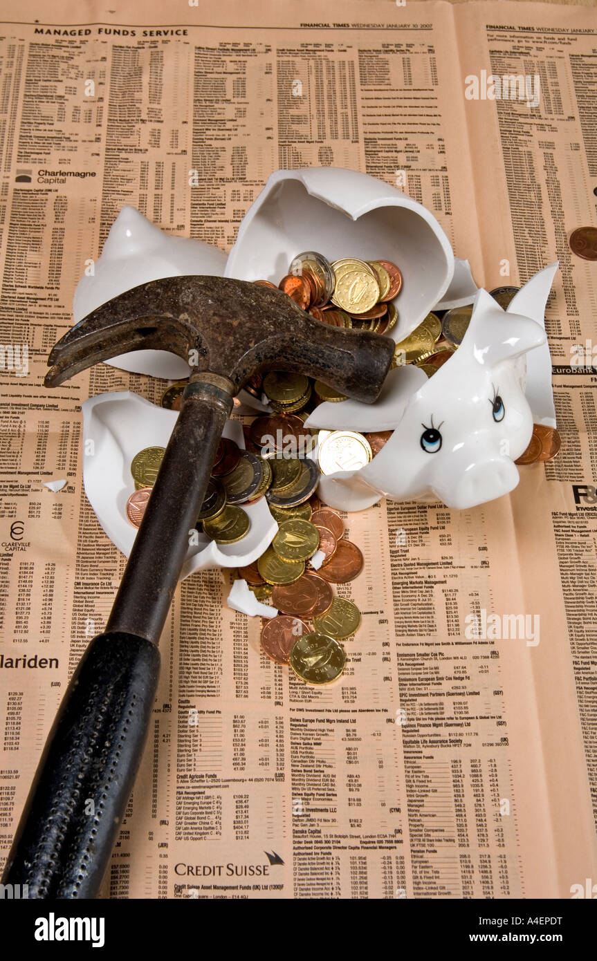 A smashed money piggy bank with coins falling out with the hammer that ...