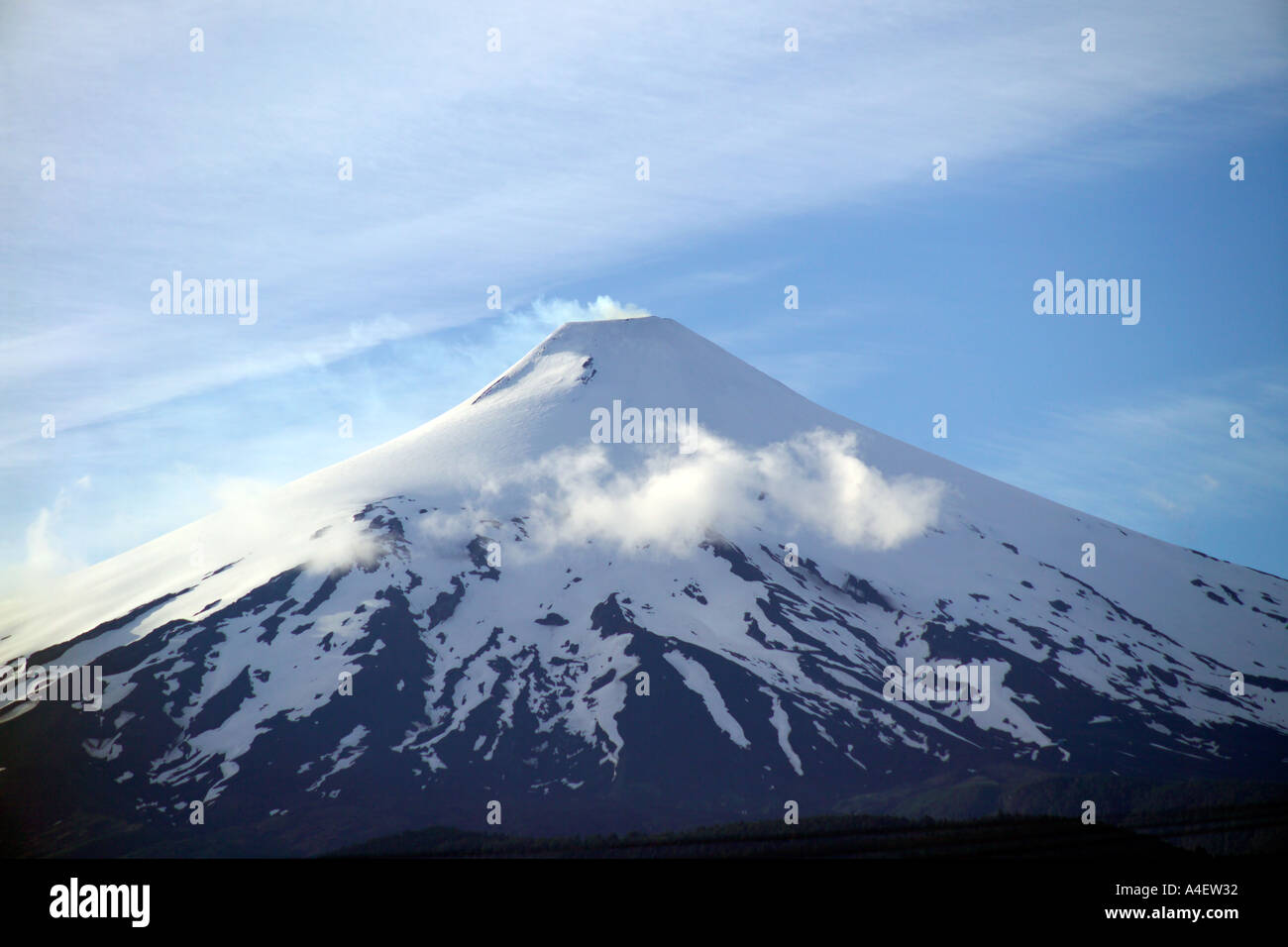 The snow capped cone of Villarrica Volcano viewed from Pucom La ...