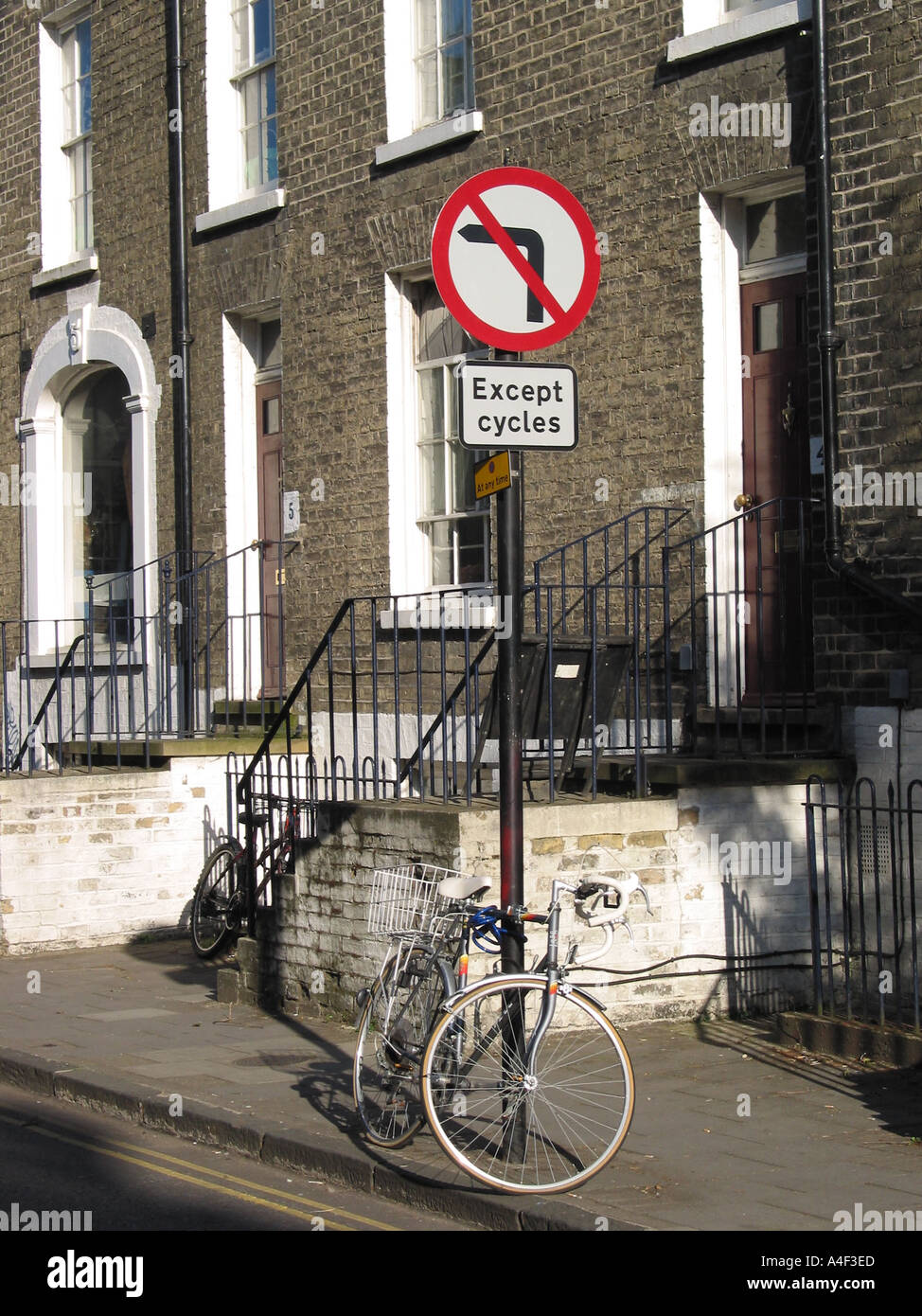 Bicycle tied up to sign post Except Cycles Street Sign Cambridge Street ...