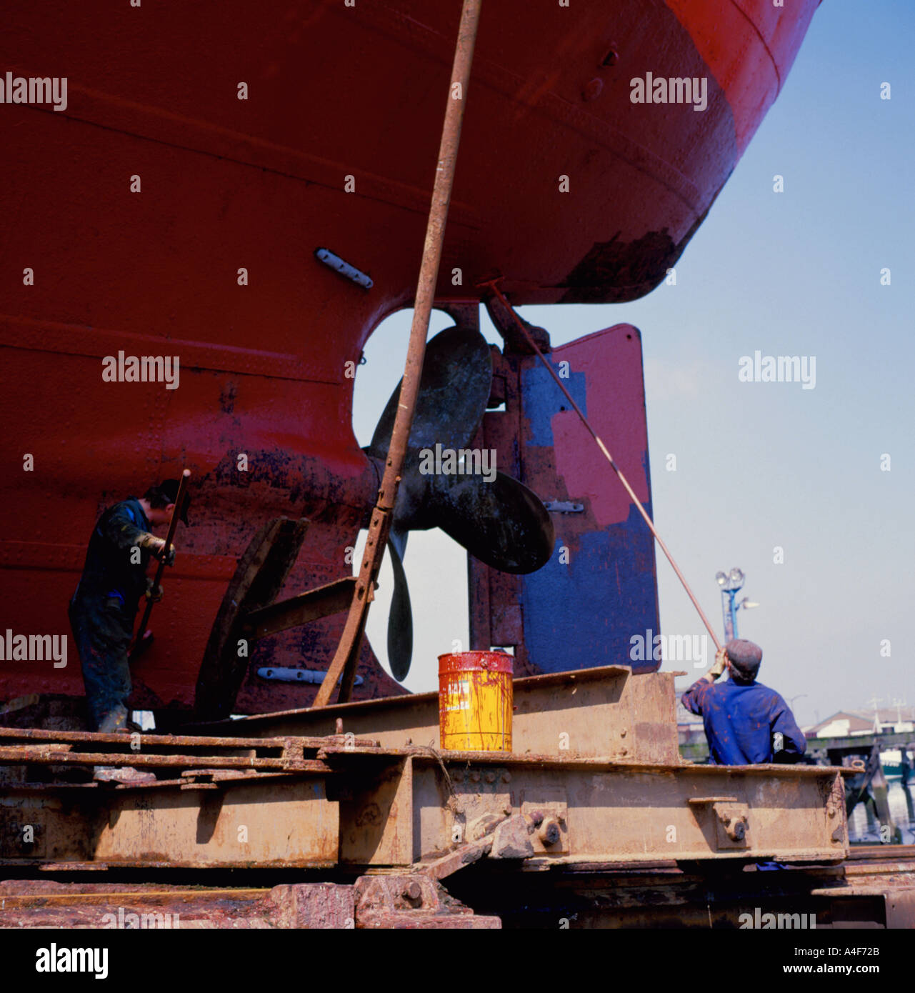 Painting a ships hull, Grimsby, Humberside, North Lincolnshire, England ...