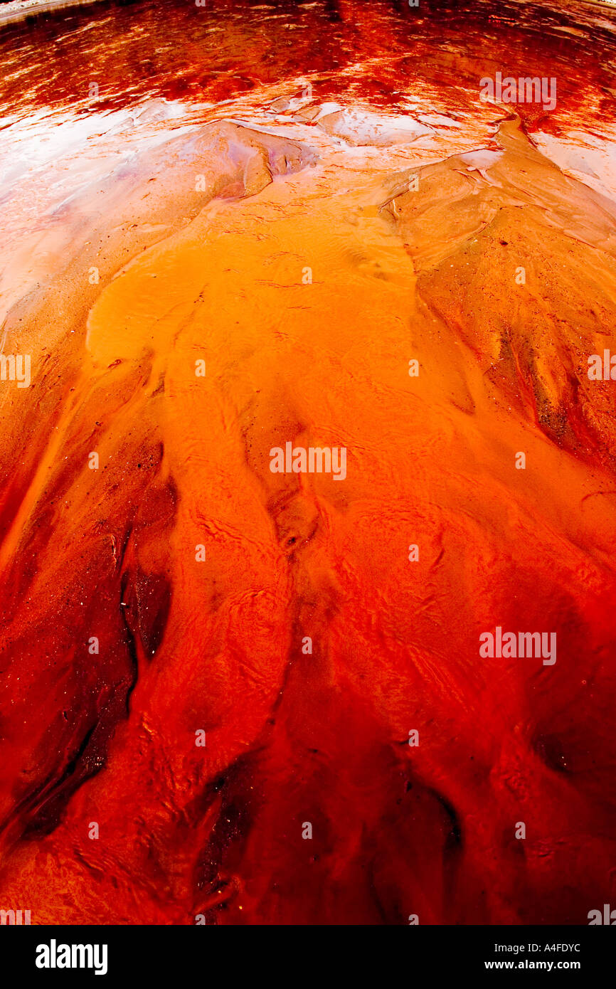 Red sand flows along the beach like laver flowing down a hill side ...