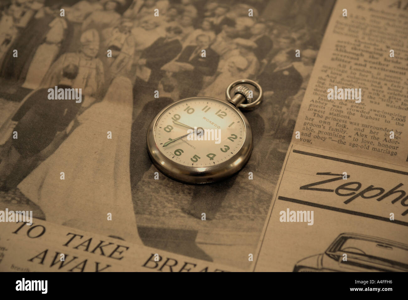 Pocketwatch on a newspaper Stock Photo - Alamy