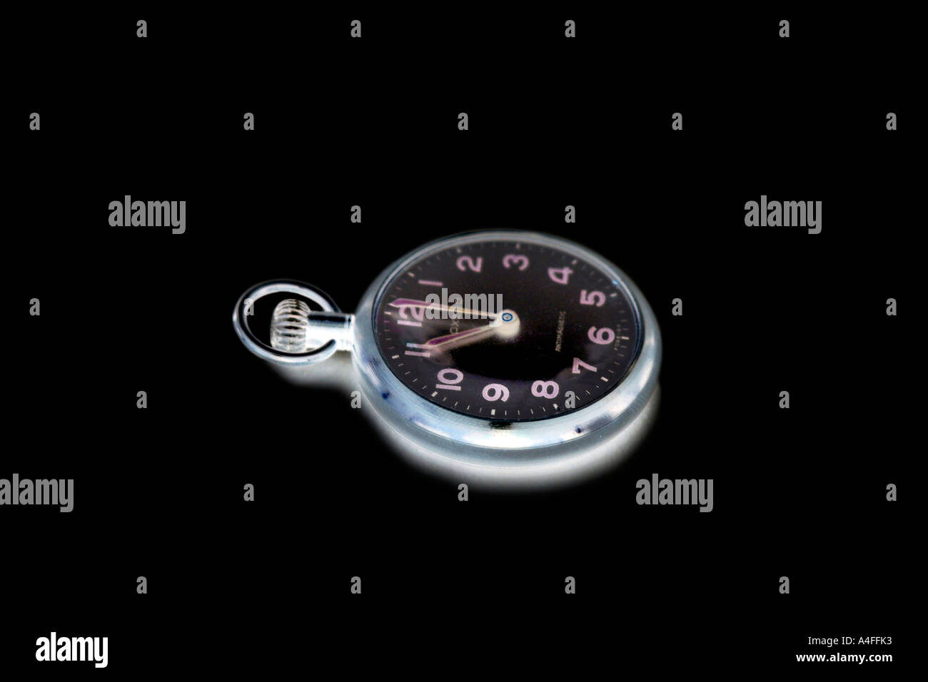 Pocketwatch against a black background Stock Photo - Alamy