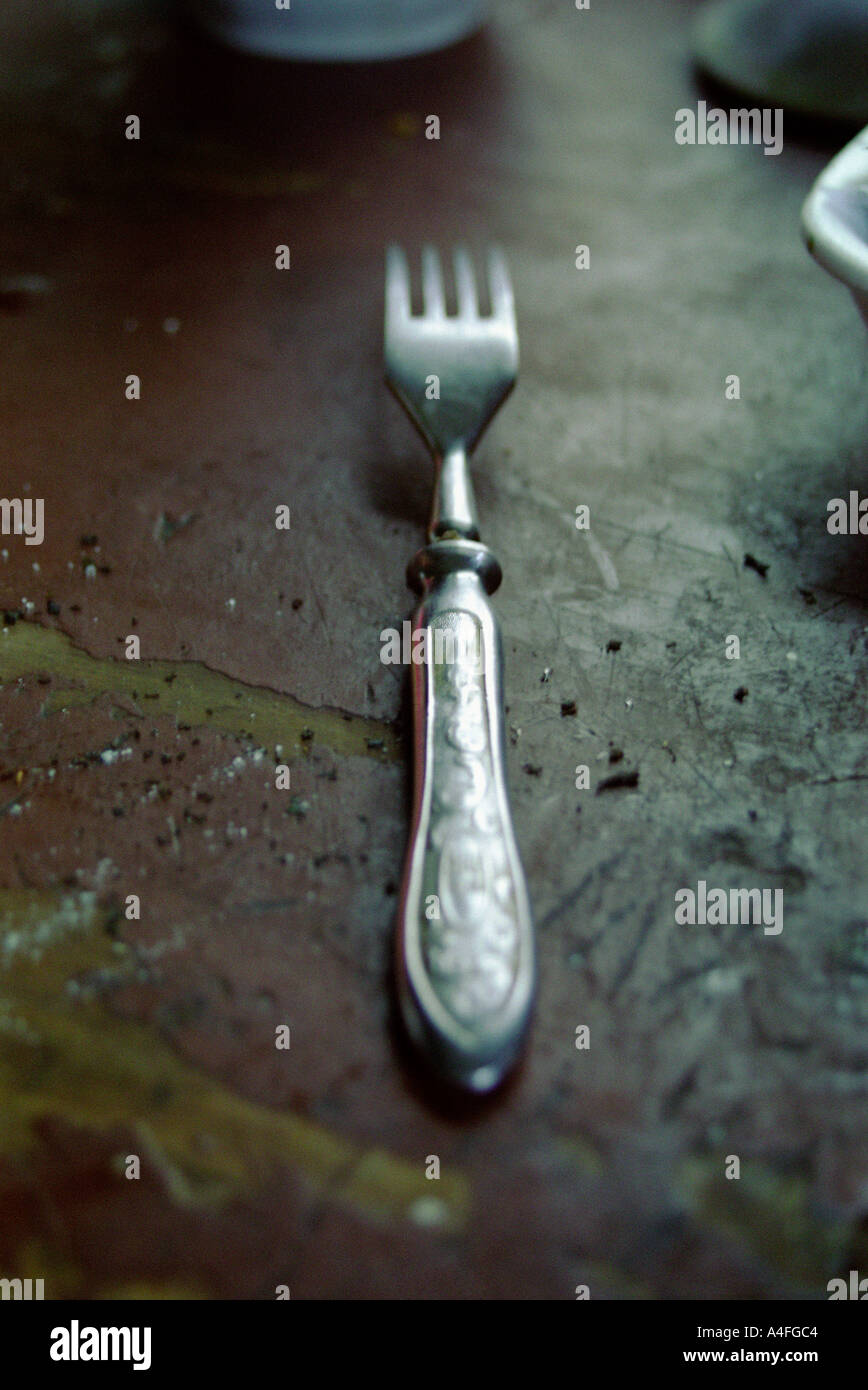 An old soviet metal fork on an old wood table Stock Photo - Alamy