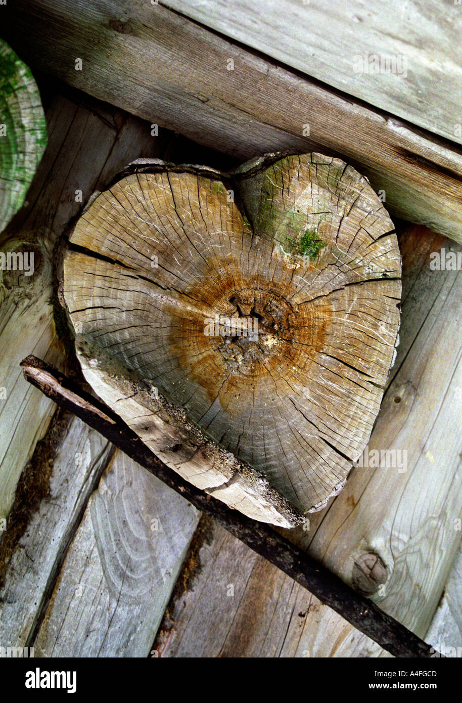 A heart shaped log in a log house Russia Stock Photo - Alamy