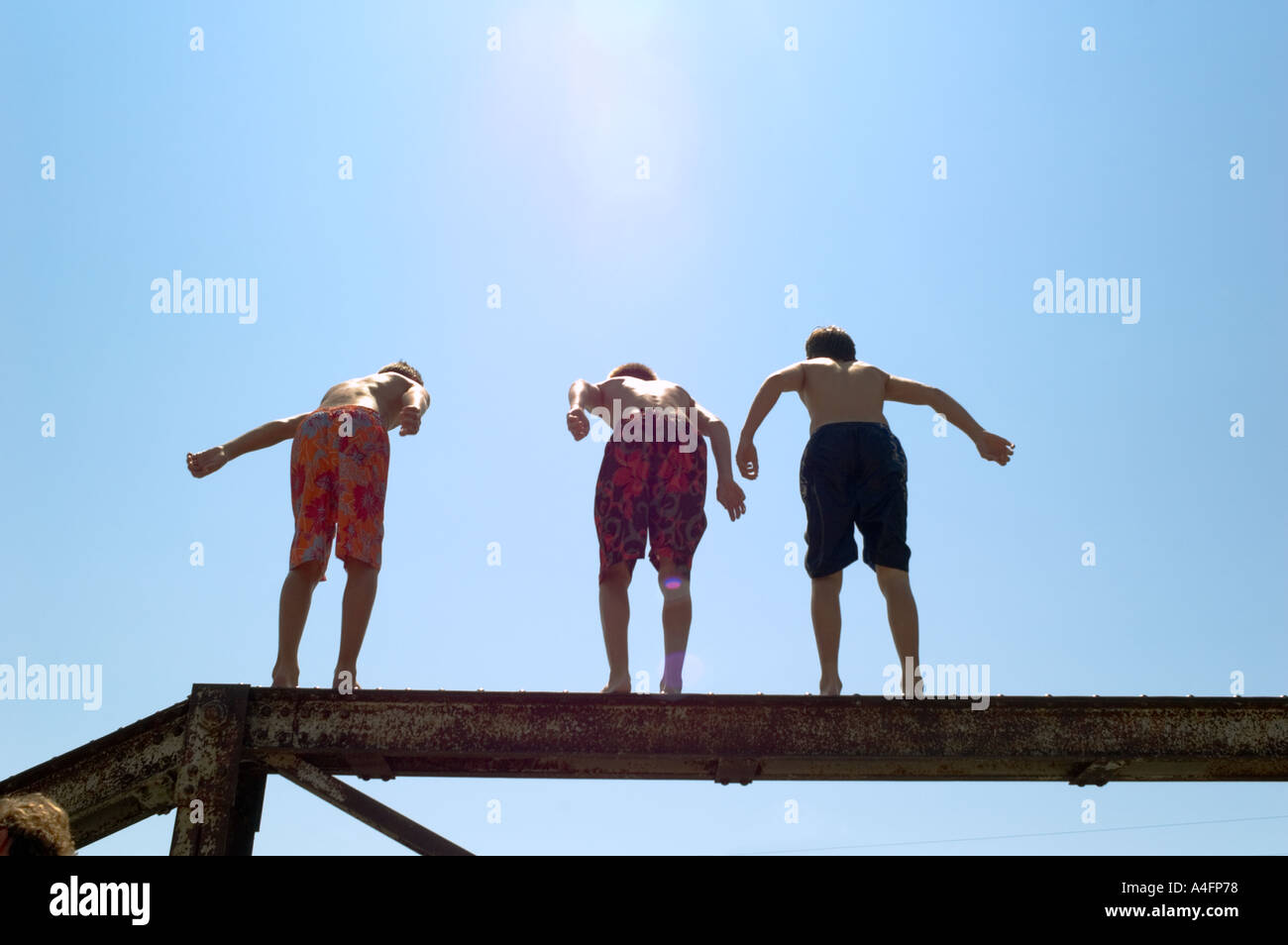 Three boys jumping off bridge hi-res stock photography and images - Alamy