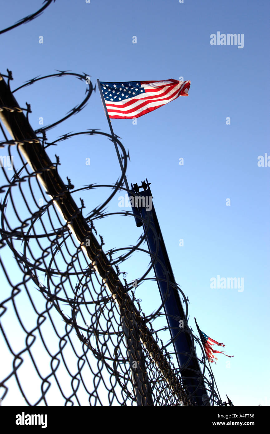 Usa American flag over fence and barbed wire Stock Photo - Alamy