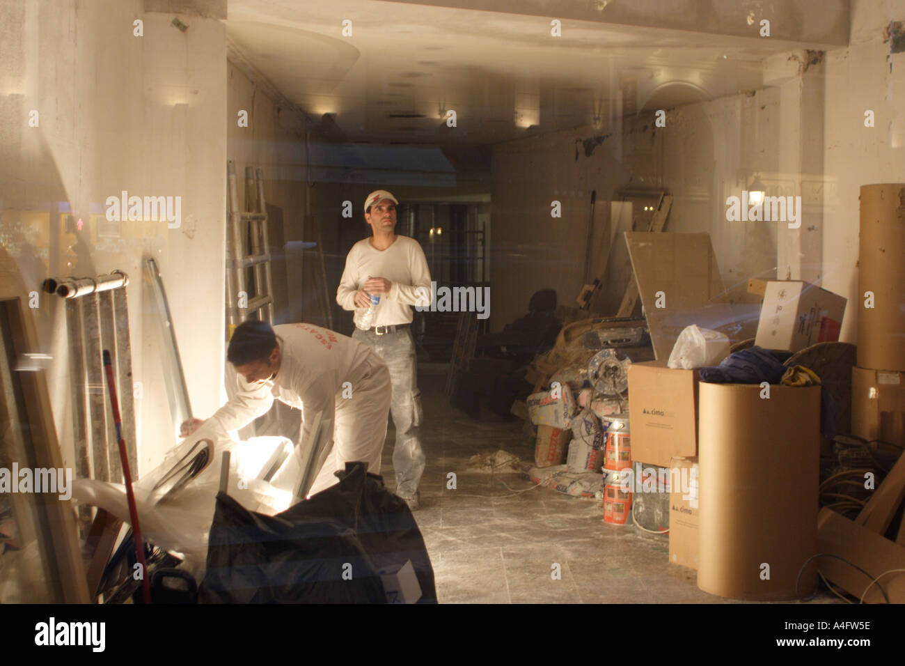 France Paris workers inside shop under renovation; seen from window on ...