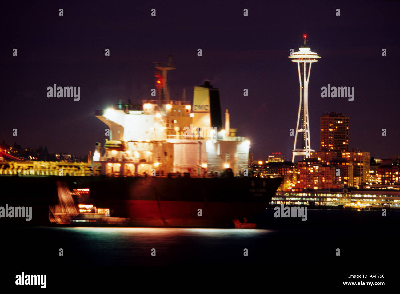 Cargo ship and Space Needle at night Stock Photo - Alamy