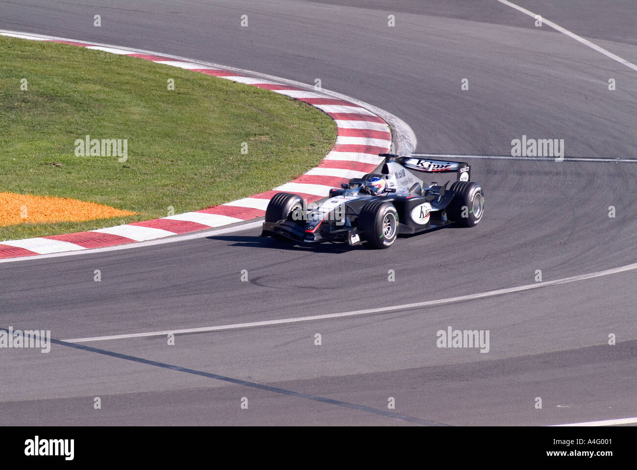 Formula 1 racing car black white body in race at turn Gilles Villeneuve ...
