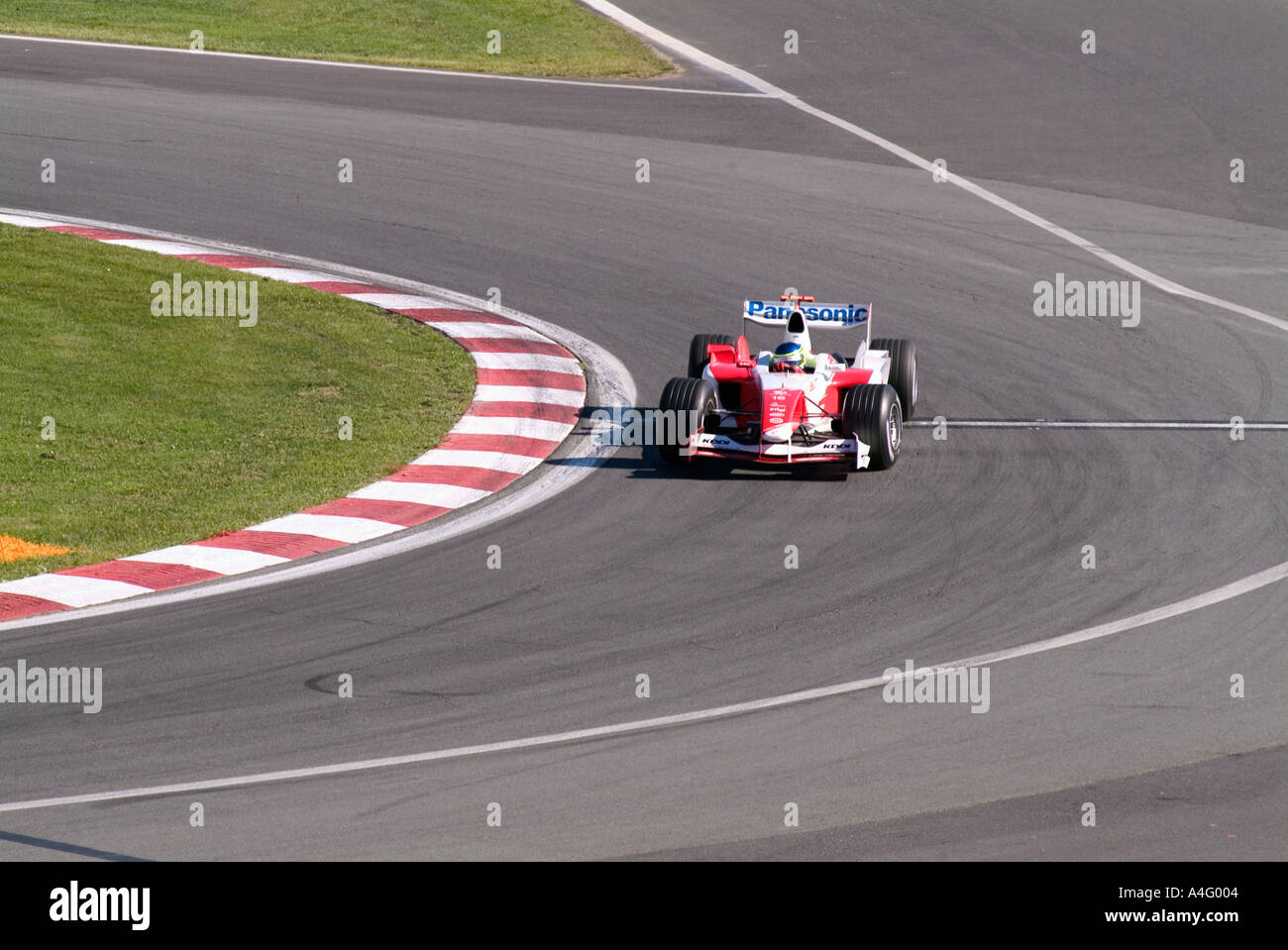 Formula 1 racing car red white body in race at turn Gilles Villeneuve ...