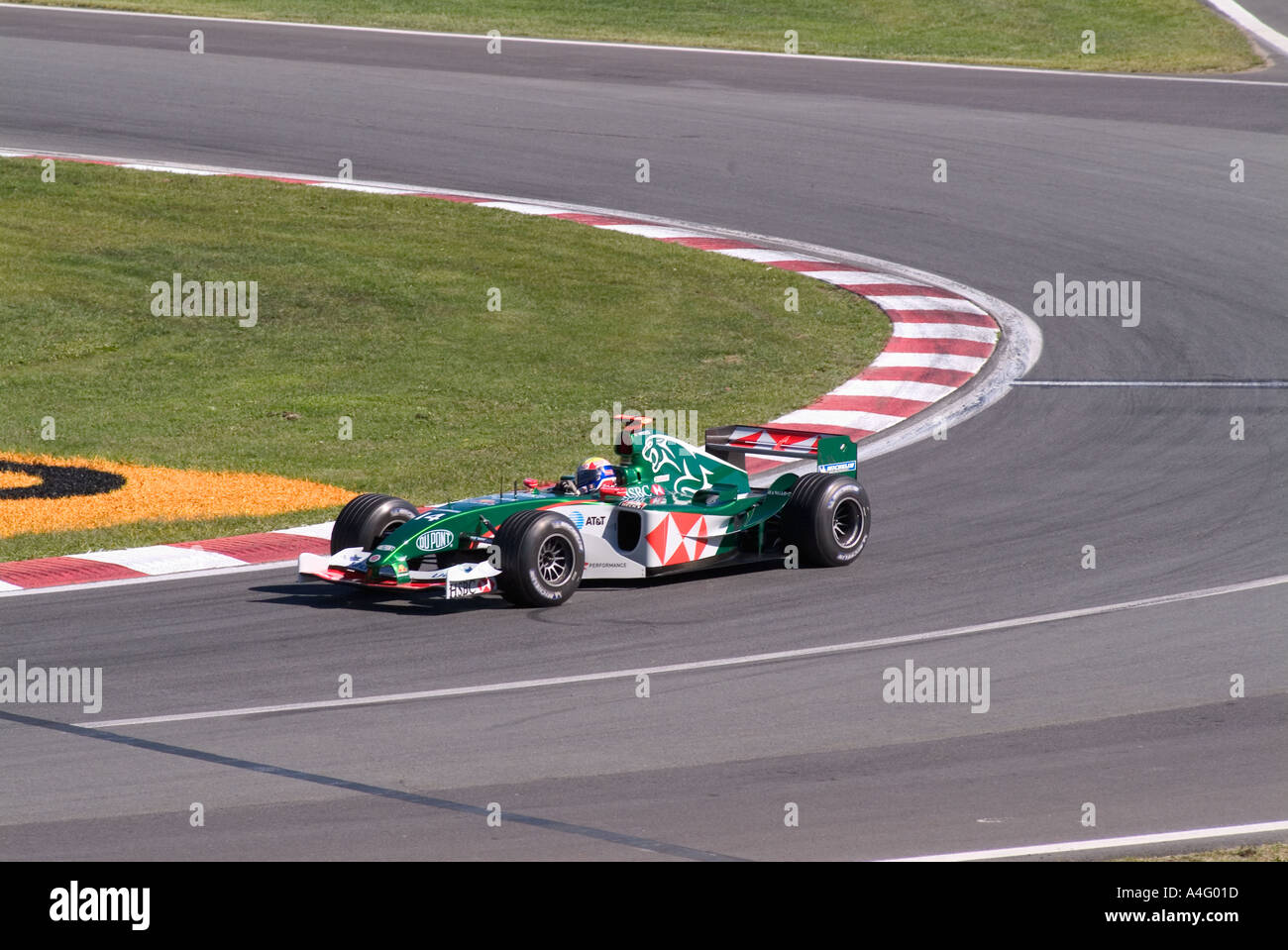 Formula 1 racing car green white body in race at turn Gilles Villeneuve ...