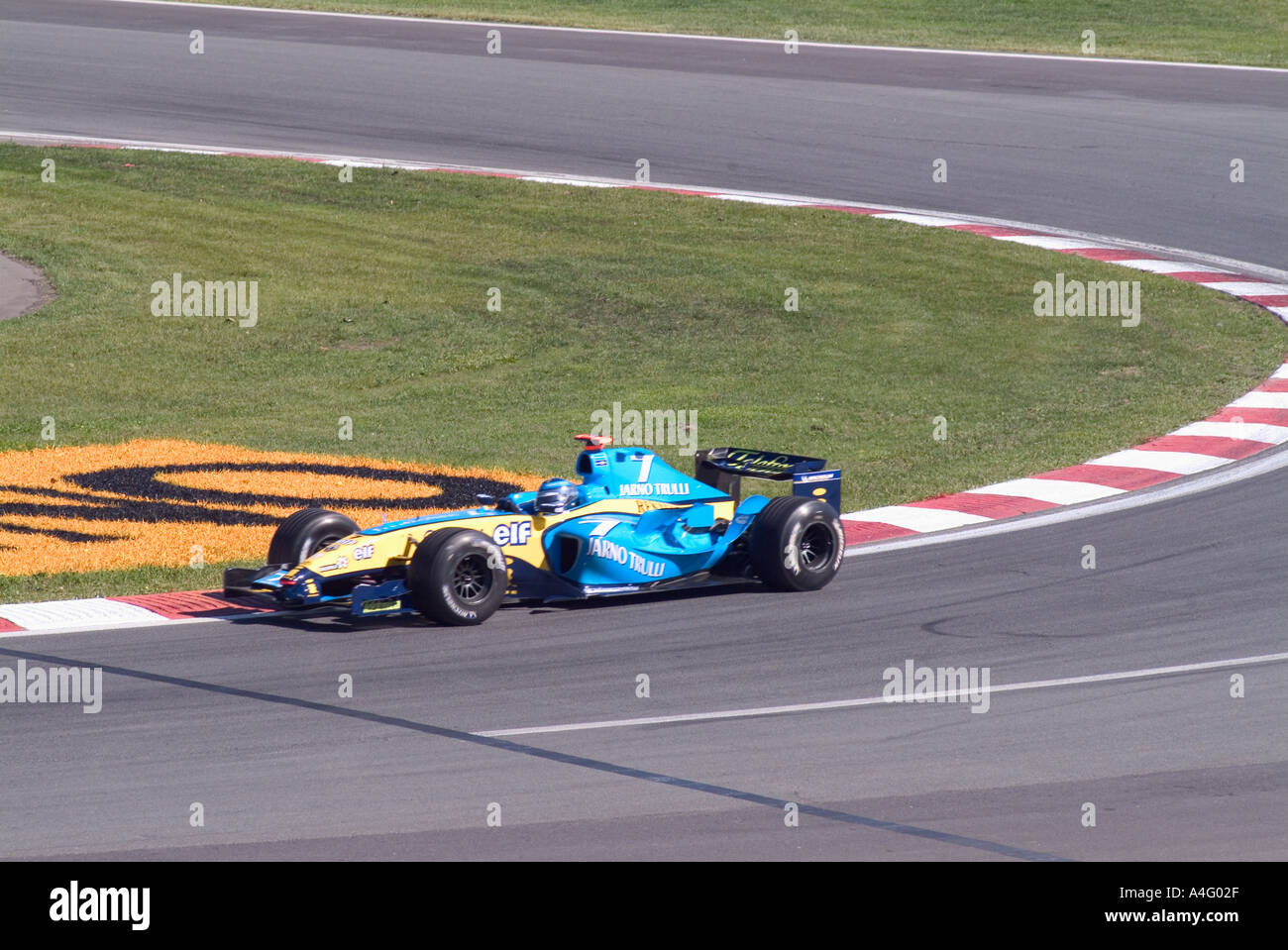 Formula 1 racing car blue yellow body in race at turn Gilles Villeneuve ...