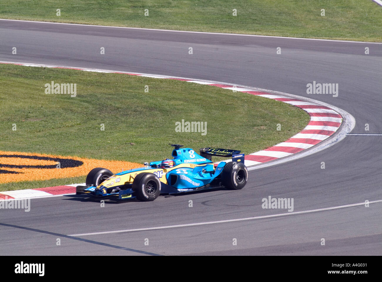 Formula 1 racing car blue yellow body in race at turn Gilles Villeneuve ...