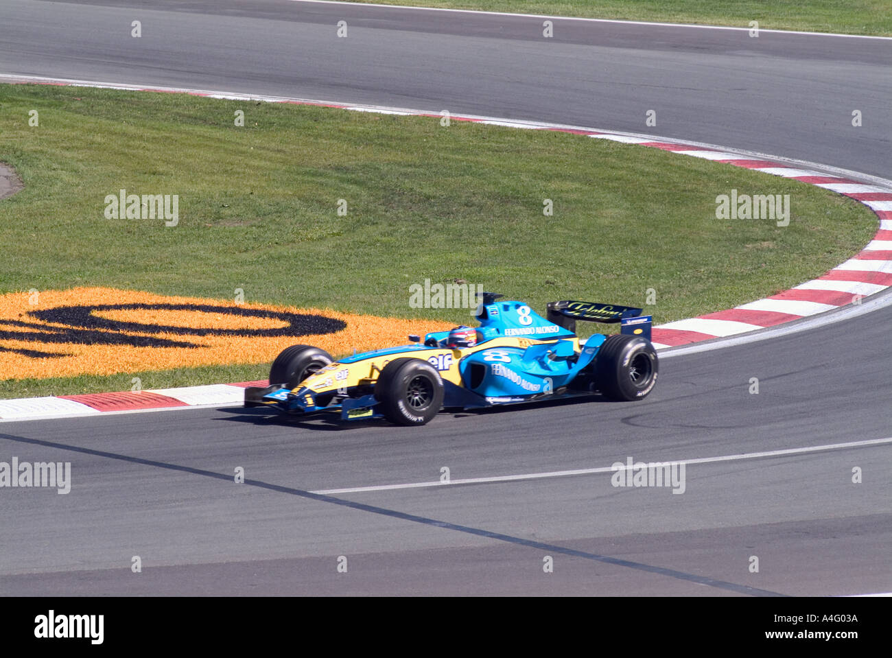 Formula 1 racing car blue yellow body in race at turn Gilles Villeneuve ...