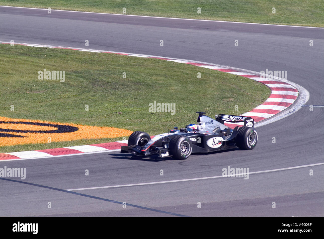 Formula 1 racing car black white body in race at turn Gilles Villeneuve ...