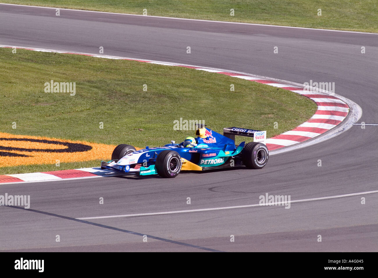 Formula 1 racing car blue green body in race at turn Gilles Villeneuve ...