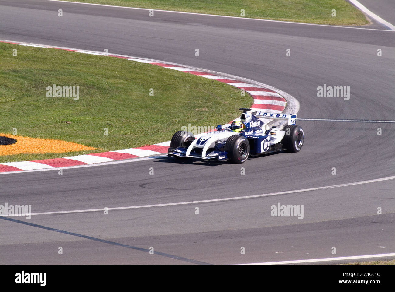 Formula 1 racing car blue white body in race at turn Gilles Villeneuve ...
