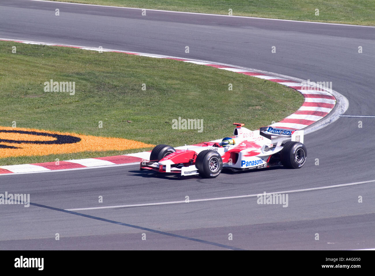 Formula 1 racing car red white body in race at turn Gilles Villeneuve ...