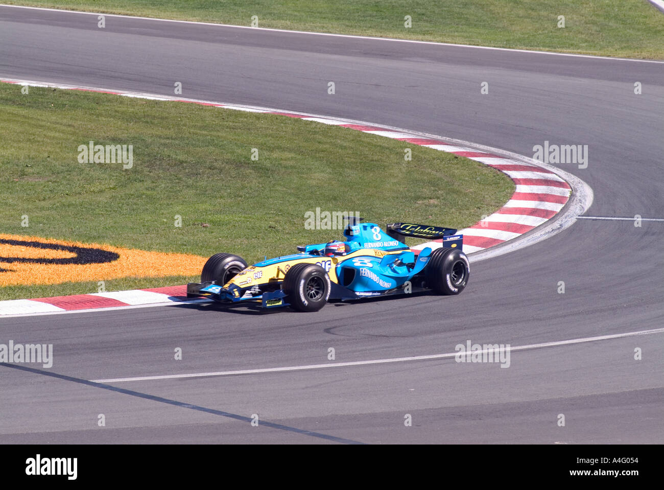 Formula 1 racing car blue yellow body in race at turn Gilles Villeneuve ...