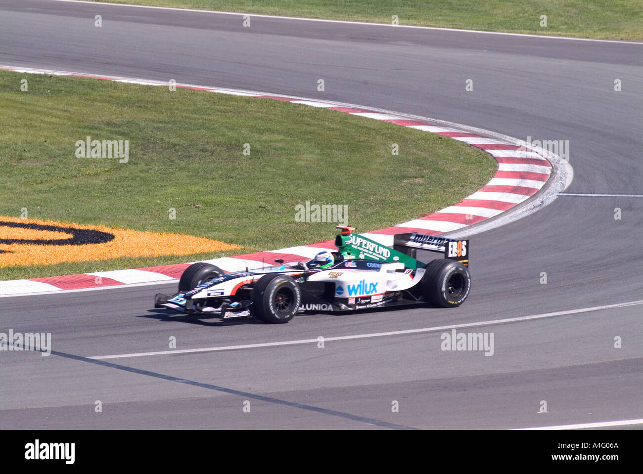 Formula 1 racing car black white body in race at turn Gilles Villeneuve ...