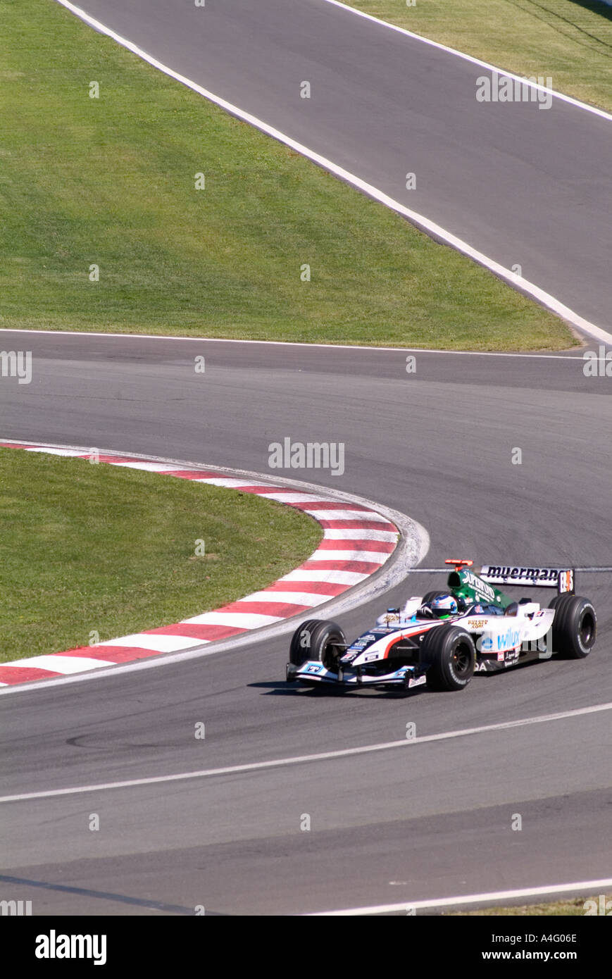 Formula 1 racing car black white body in race at turn Gilles Villeneuve ...