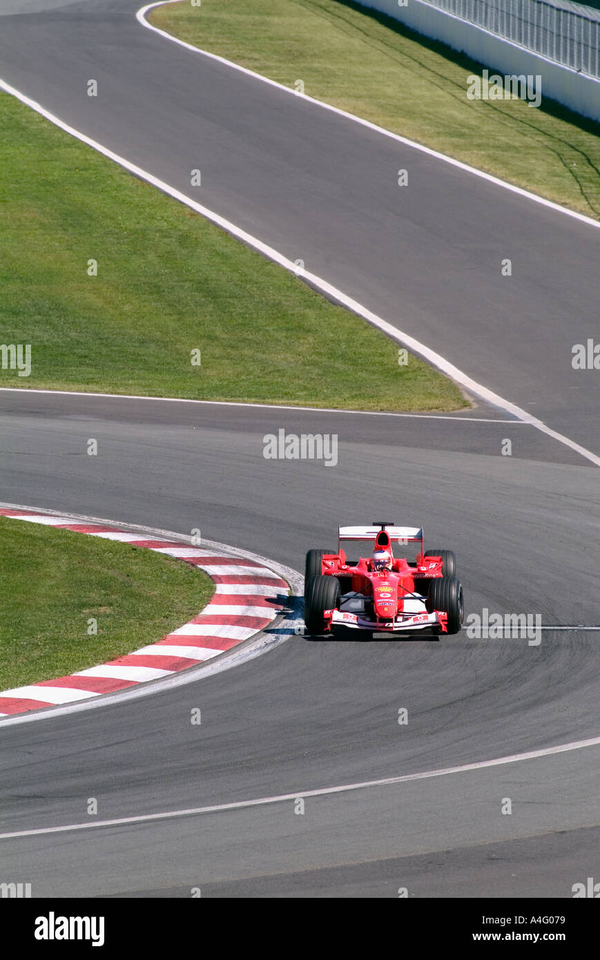 Formula 1 racing car red white body in race at turn Gilles Villeneuve ...