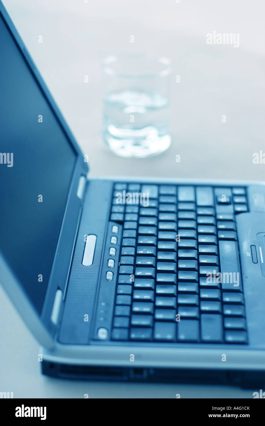 Glass water next laptop hi-res stock photography and images - Alamy