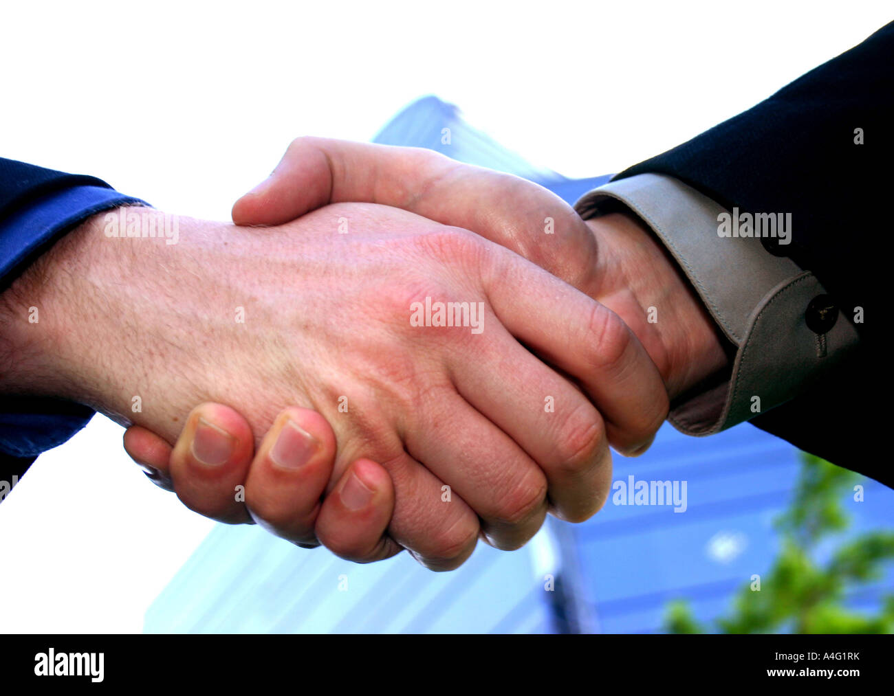 Business Men shake hands in front of a business building Stock Photo ...