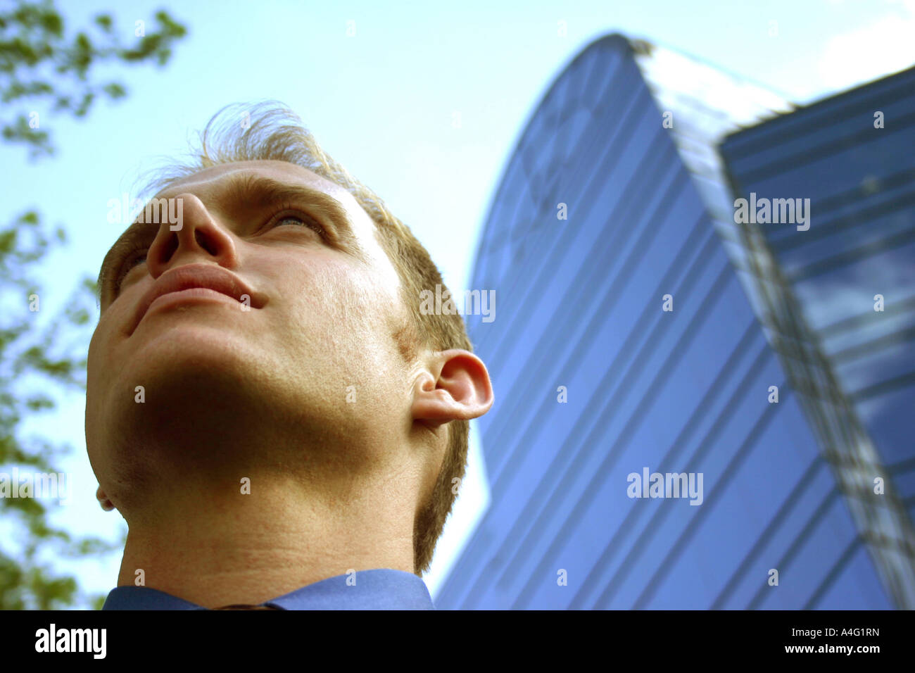 Business Man looking forward while he stands in front of a business ...