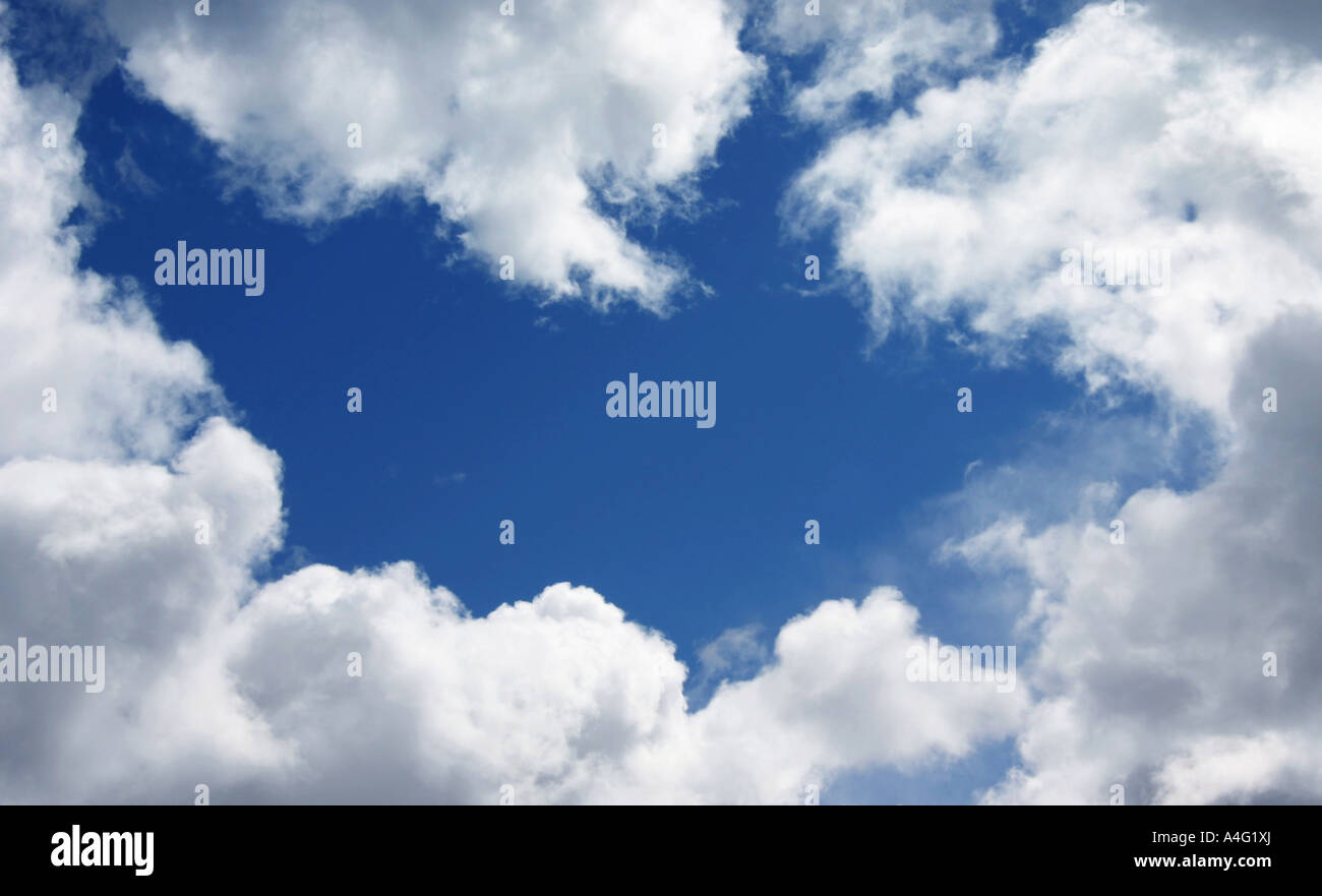 Clouds form together on a bright sunny day Stock Photo - Alamy