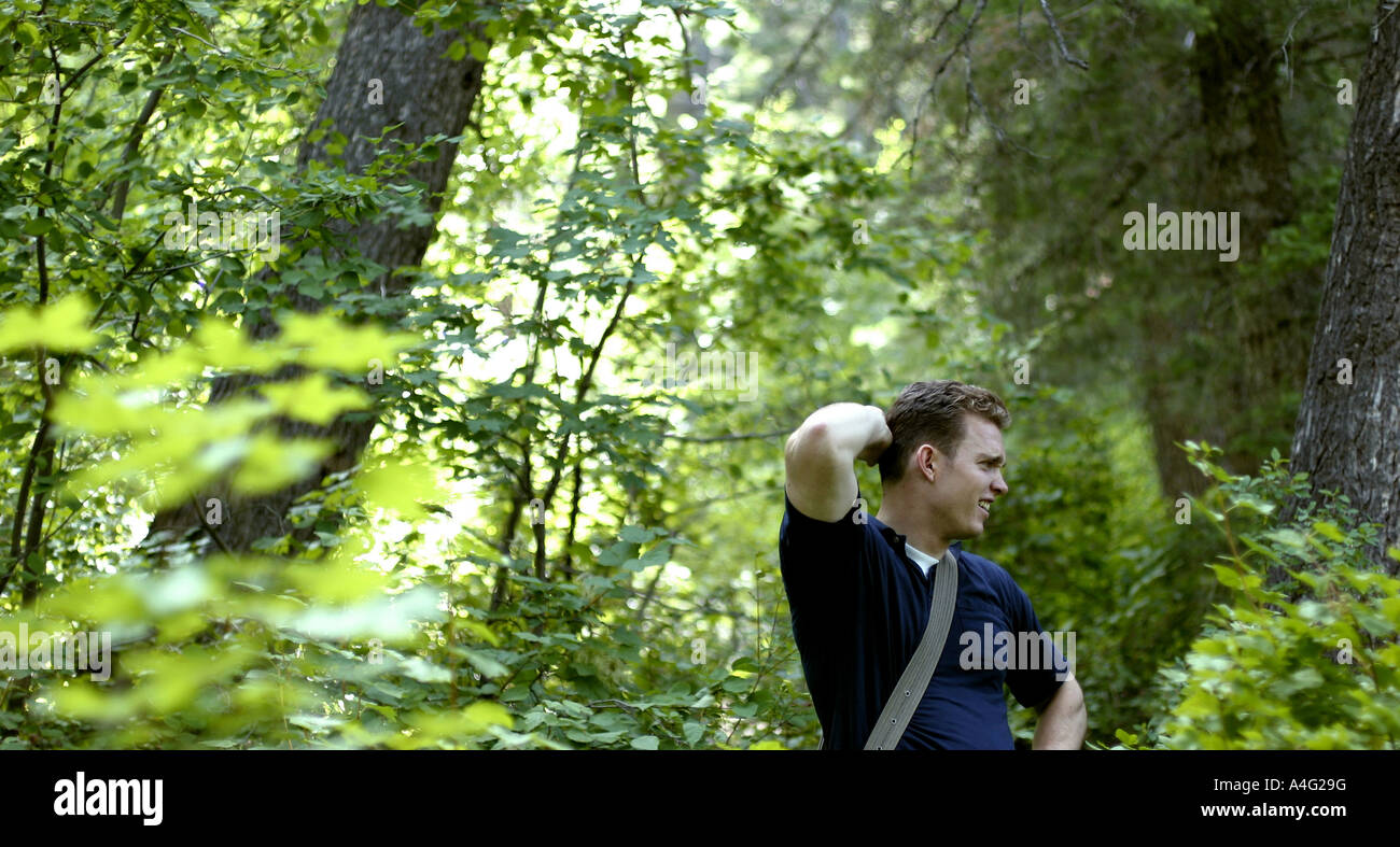 Man lost in forest with blue shirt Stock Photo - Alamy